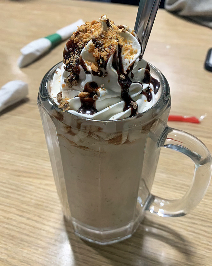 This isn't just a milkshake&mdash;it's dessert architecture with whipped cream skyscrapers and chocolate drizzle infrastructure. Spoon required.