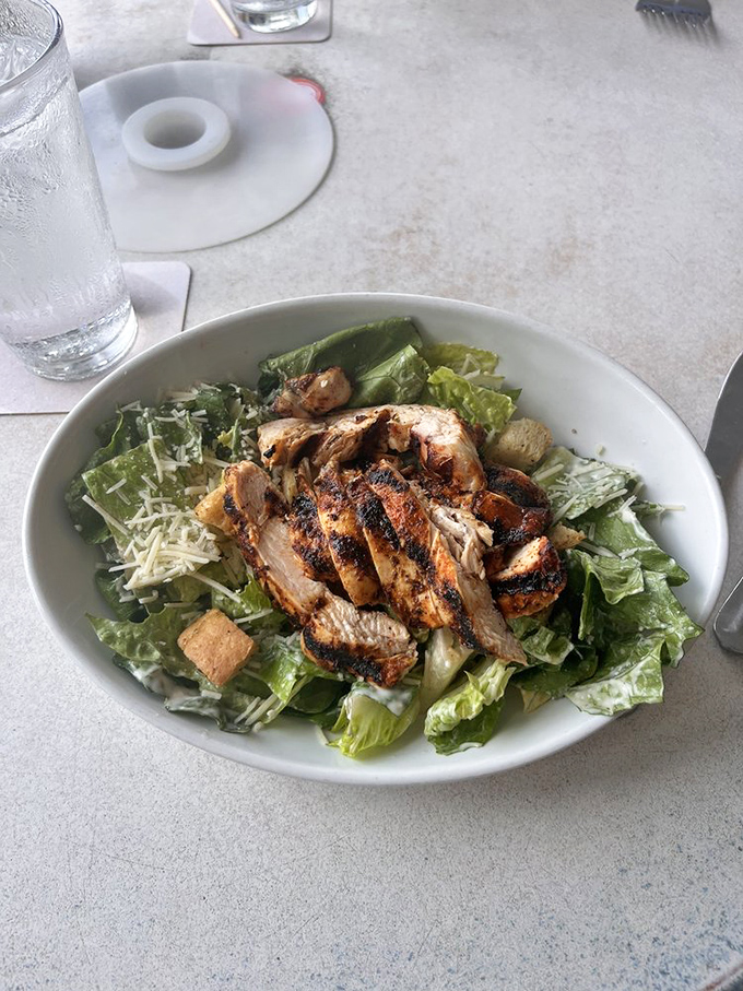 Caesar salad topped with blackened chicken that transforms rabbit food into a proper feast worth celebrating.