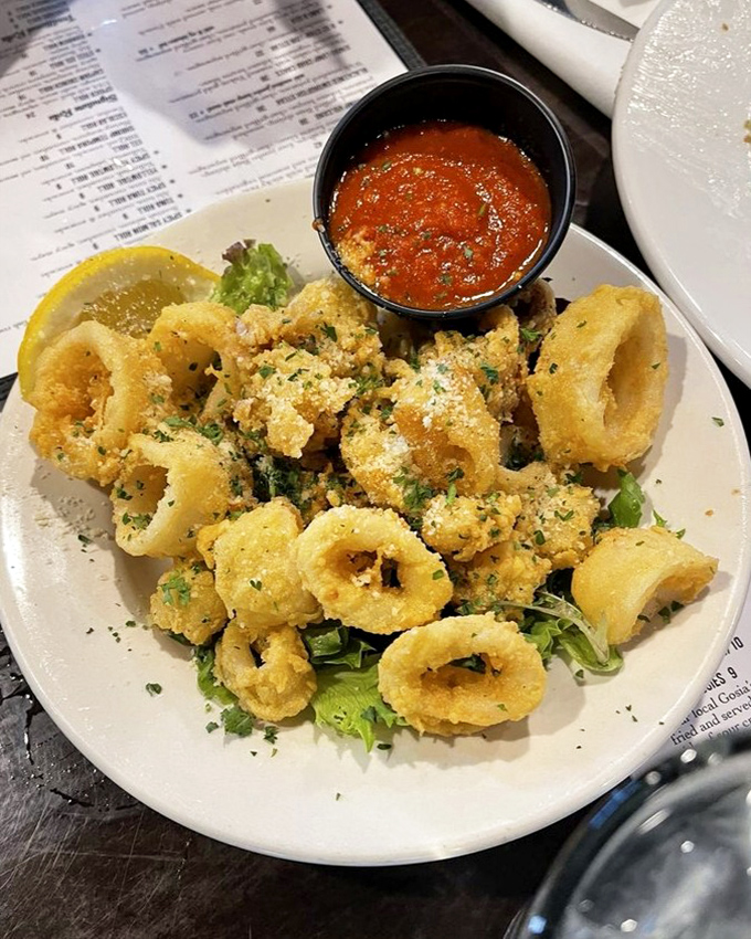 Golden calamari rings that crunch like autumn leaves but taste like ocean treasures, perfectly paired with marinara for dunking adventures.