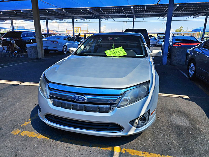 Automotive dreams for sale! This Ford Fusion waits patiently for its next owner, sporting a neon price tag and the promise of open roads.