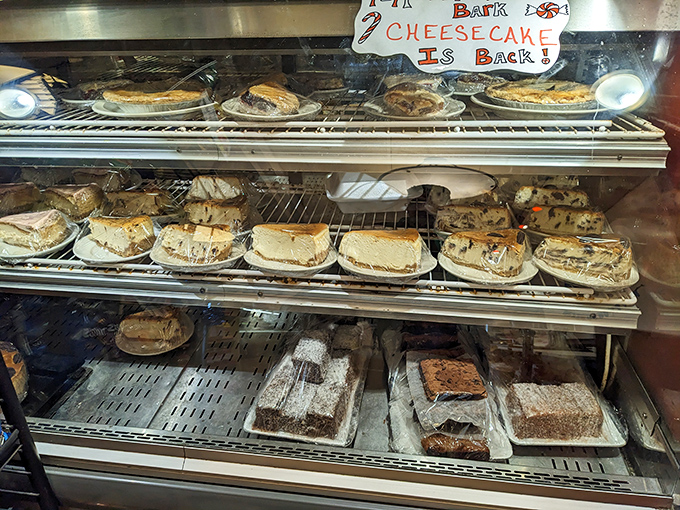 The dessert case is basically an adult version of a toy store window. That "Bark Cheesecake is Back" sign should be considered breaking news.