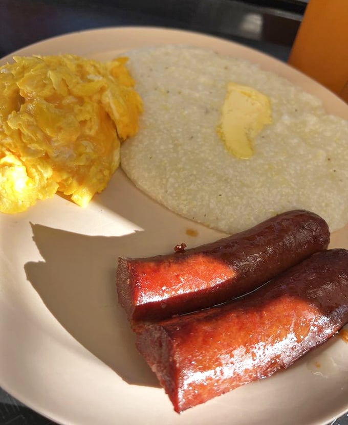 Sunshine on a plate: fluffy scrambled eggs, buttery grits, and sausage links with the perfect snap &ndash; breakfast doesn't get more honest than this.