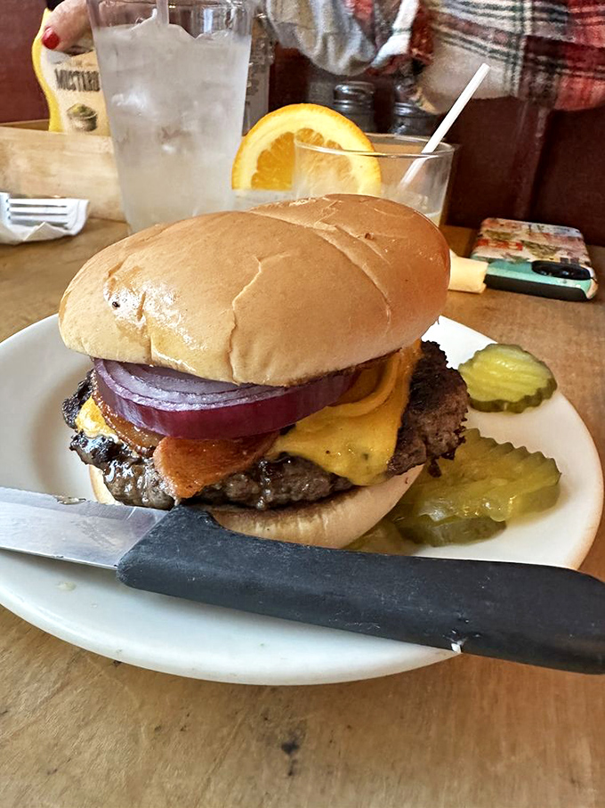 The classic American cheeseburger, perfected. That melted cheese cascading down the patty isn't just delicious&mdash;it's practically patriotic.