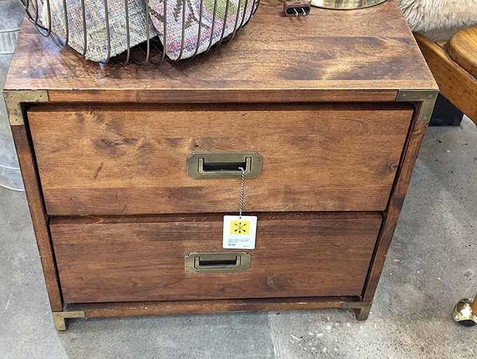 This wooden chest of drawers has more personality in its brass handles than most modern furniture has in its entire existence.