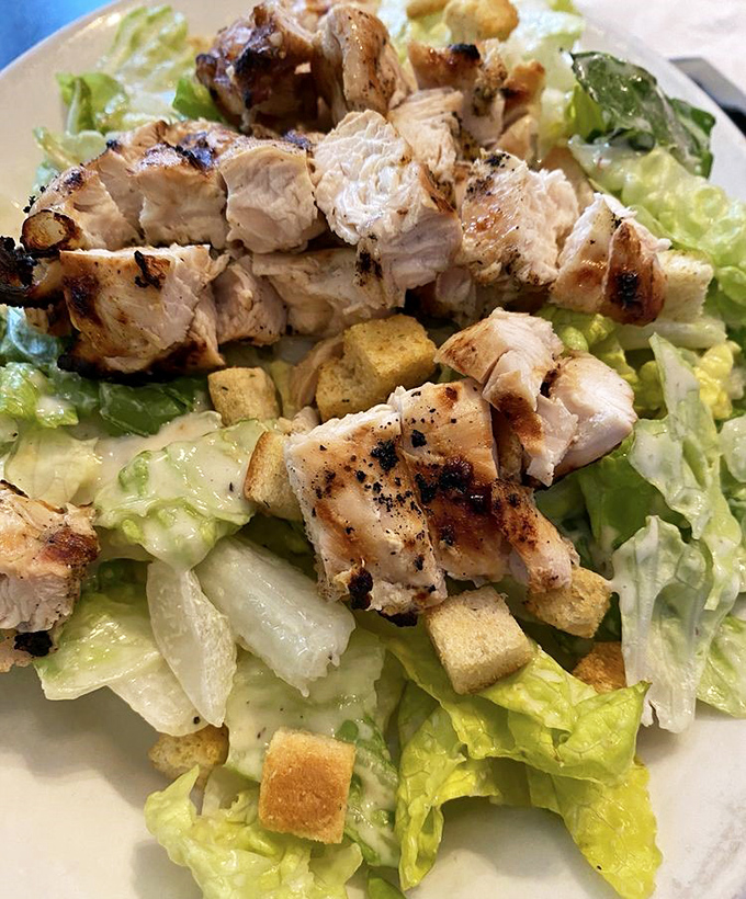 Caesar salad topped with grilled chicken that makes eating your greens feel like celebration.