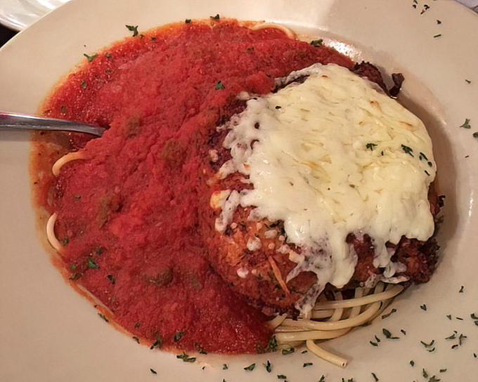 Chicken Parmesan that bridges Old World tradition with American appetite. That melted cheese pull would make any food photographer weep with joy.