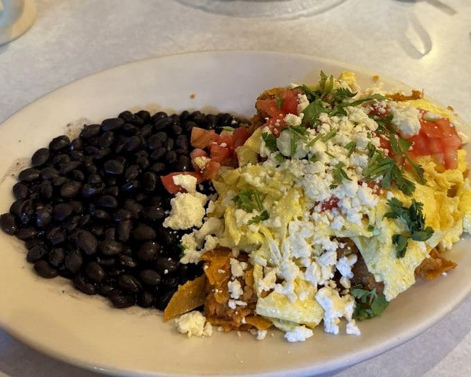 Black beans and eggs with a shower of fresh cheese and herbs&mdash;proof that breakfast knows no borders at Elmo's.