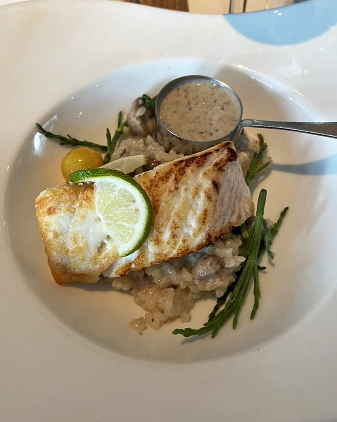 Chilean sea bass that's having a better hair day than I've had all year, garnished with fresh herbs and seasonal berries.