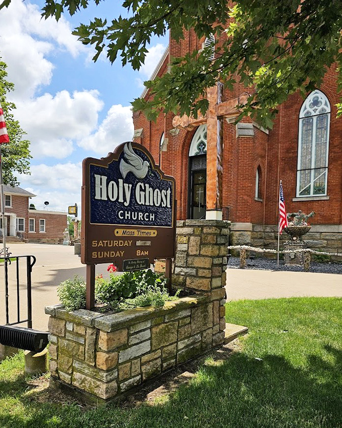 Holy Ghost Church stands proudly beside its famous grotto, the brick sanctuary providing a perfect backdrop for stone artistry.