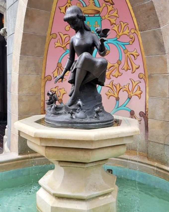 Cinderella's fountain offers a quiet moment of reflection amid the park's hustle, a bronze reminder of the story behind the spectacle.