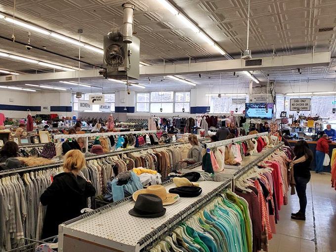 Shoppers navigate the well-organized aisles like seasoned explorers. The blue stripe running along the wall serves as both decoration and navigational aid.