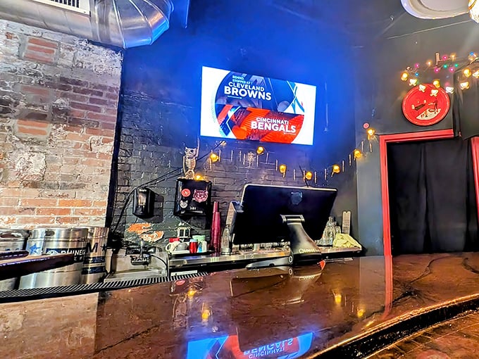 A glowing screen, exposed brick, and twinkling string lights set the scene&mdash;proof that the best bar seats come with atmosphere as rich as the pour.