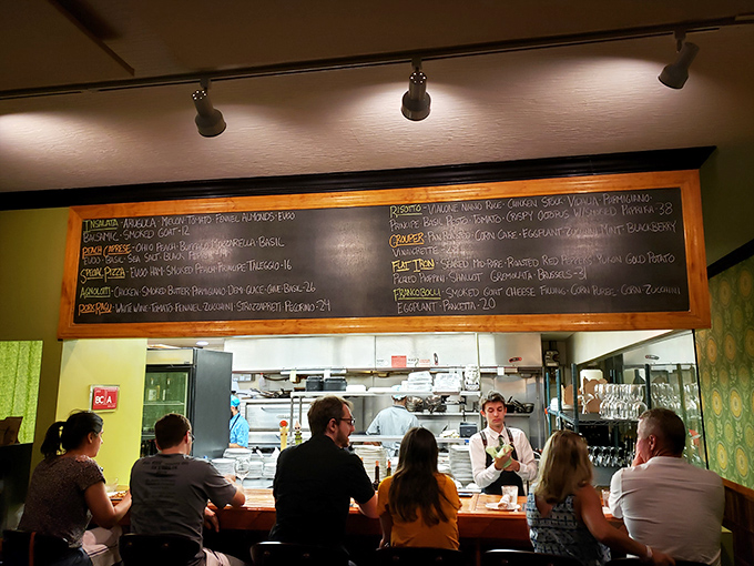 The bar offers front-row seats to the kitchen drama, where beer taps stand ready like loyal soldiers awaiting commands.