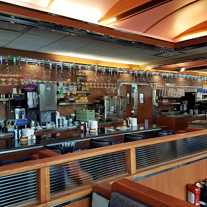 The counter and kitchen&mdash;diner theater at its finest, where coffee mugs are never empty and the griddle sizzles with constant promises.