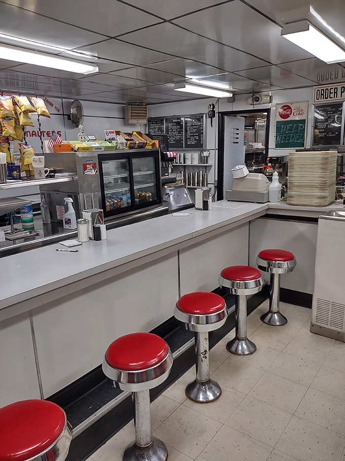 The counter where magic happens&mdash;classic red stools invite you to sit and watch short-order choreography that's been perfected over decades.