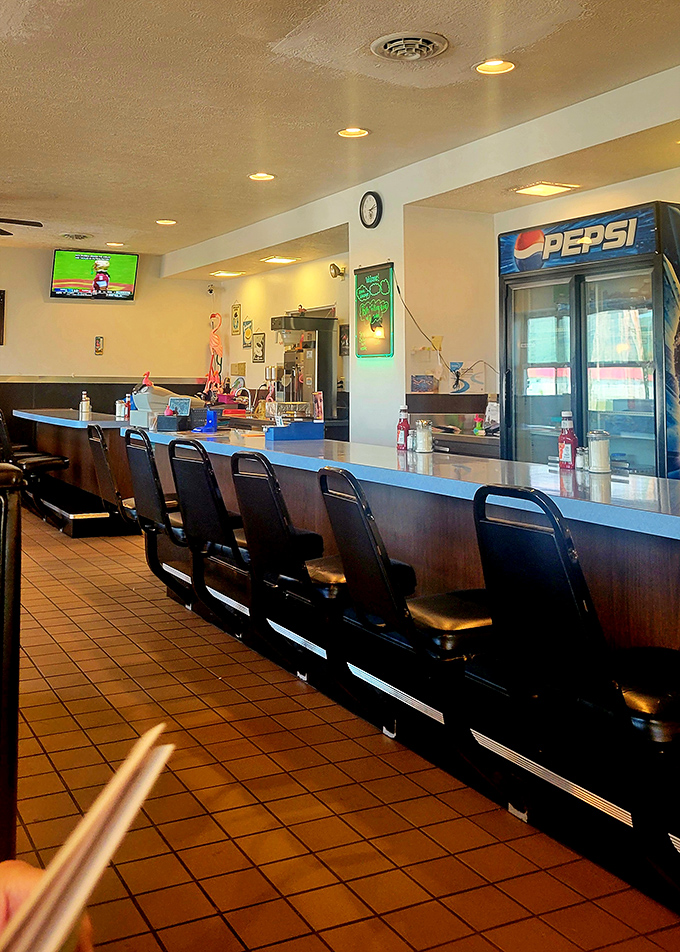 Counter seating where regulars have worn their loyalty into the vinyl. The best reality show is always other diners.