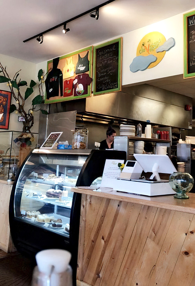 Behind this counter, vegan magic happens daily. The sunny logo and wooden finishes create a warm welcome that says, "Yes, plants can be this exciting."