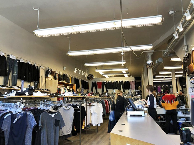 Behind the sleek wooden counter, fashion gatekeepers evaluate potential inventory while shoppers browse&mdash;the circular economy spinning in real time.