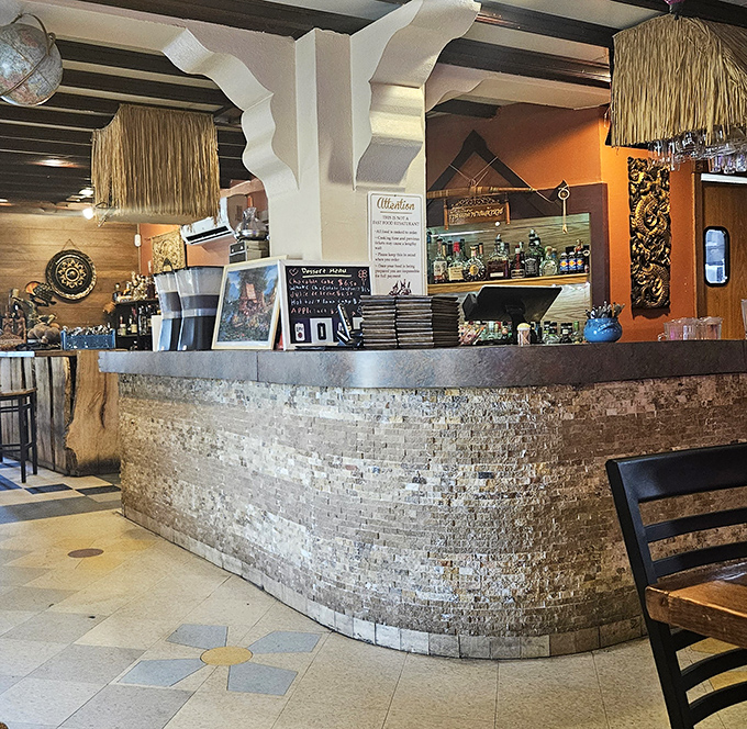 The bar area combines rustic stone with bamboo accents, creating a textural backdrop for the flavor adventures that await.