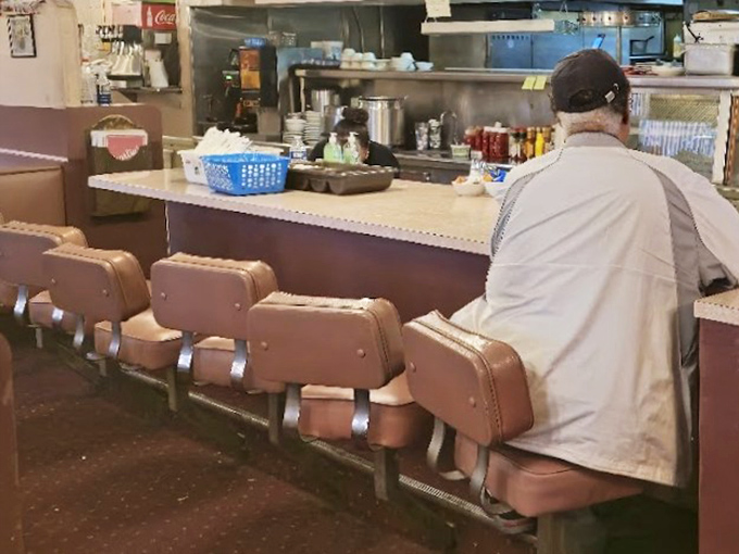 The counter seats&mdash;where solo diners become regulars and the coffee never stops flowing. Pure diner poetry in motion.