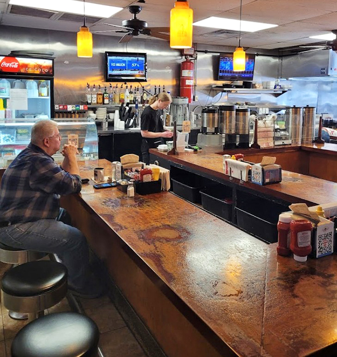 The well-worn counter tells stories of countless elbows, coffee cups, and life-changing conversations. Wood doesn't lie about its age or its importance.