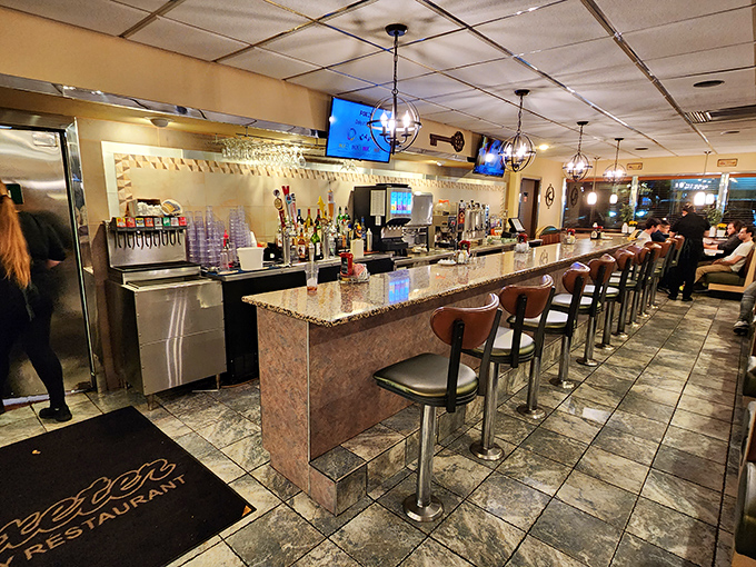 The counter seating provides front-row seats to kitchen magic, where culinary dreams transform into delicious reality daily.