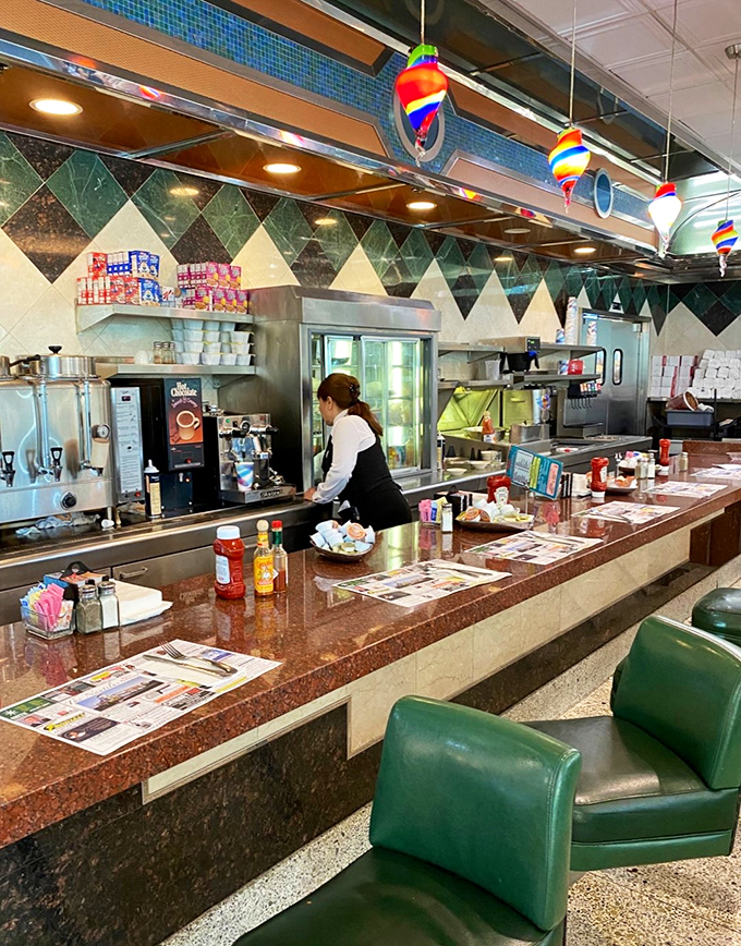 The counter &ndash; diner diplomacy in action, where strangers become temporary neighbors united by coffee and the morning paper.