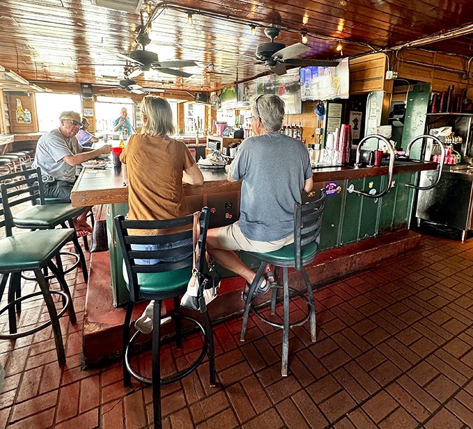 Even the bar stools have stories to tell, worn smooth by generations of locals who know exactly where to find honest food and strong drinks.