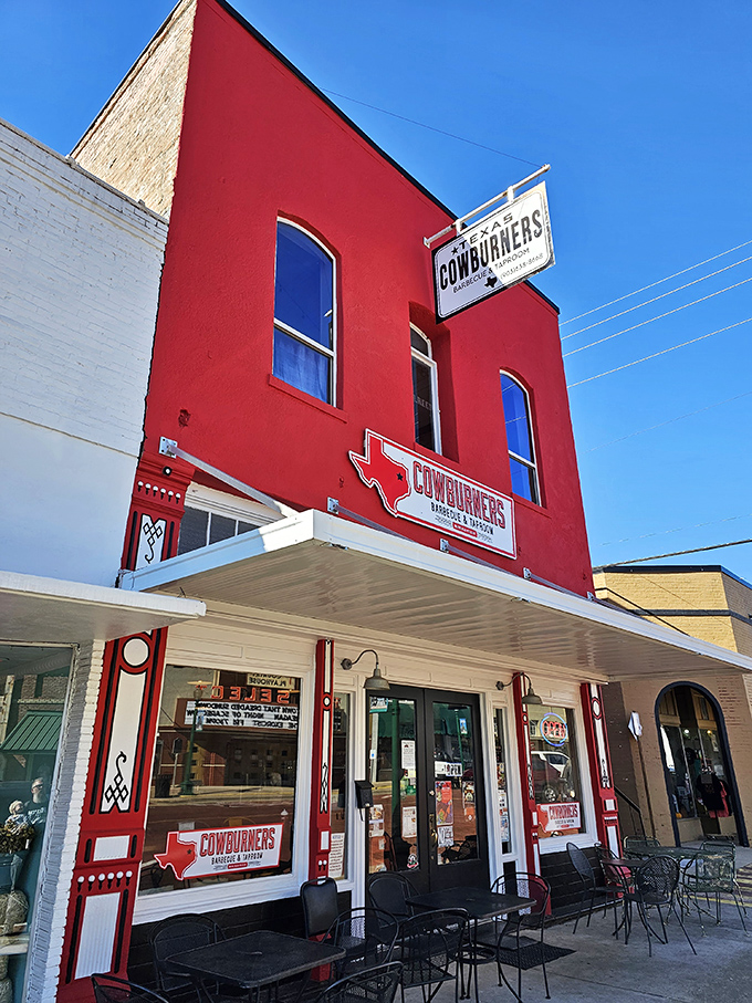 CowBurners' bold red facade stands out like a carnivore's beacon on Mineola's main street, promising Texas-sized BBQ satisfaction to meat lovers.