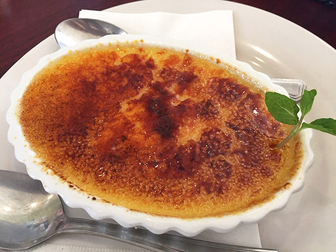 
Cr&egrave;me br&ucirc;l&eacute;e with a sugar crust so perfectly torched it makes a satisfying "crack" that's music to dessert lovers' ears. That mint leaf is the green light saying "Go!" 