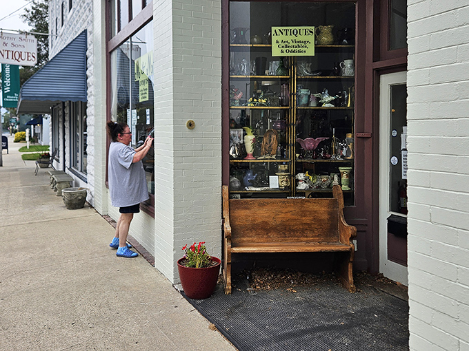 Window shopping becomes an art form at this antique store. That wooden bench invites you to sit and contemplate your next treasure.