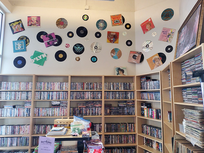 The media wall: where vinyl records and DVDs create a nostalgic timeline of entertainment history, punctuated by album art that doubles as d&eacute;cor.