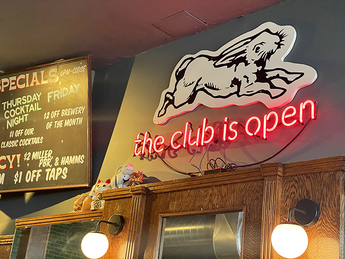 "The club is open" glows in neon, featuring the cafe's signature rabbit. A whimsical beacon for hungry souls seeking comfort food salvation.