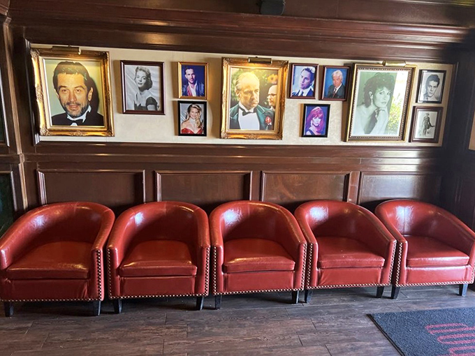 Hollywood glamour meets steakhouse charm with these vintage portraits. The red club chairs below seem to whisper, "Stay awhile."