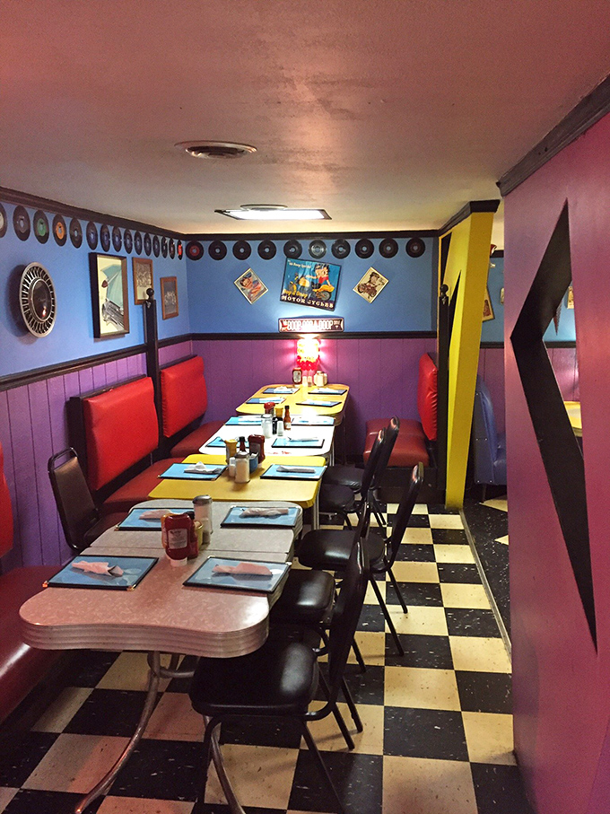 The booth area feels like dining inside a joyful 1950s vision of the future, complete with vinyl seats and a border of vintage records.