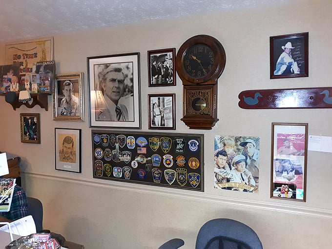 The wall of fame showcases Mayberry connections &ndash; Andy Griffith's hometown pride displayed alongside badges from visiting police departments nationwide.