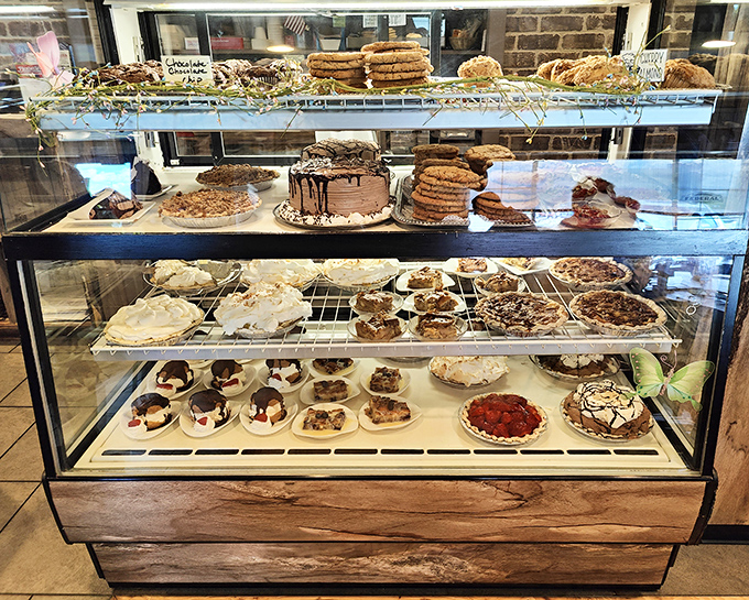 The dessert case &ndash; a glass museum of temptation where willpower goes to die. Each shelf tells a different sweet story.