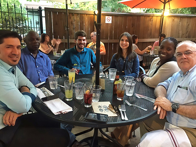 The patio gathering that makes you wish these were your actual friends. Everyone looks like they're in on a delicious secret.