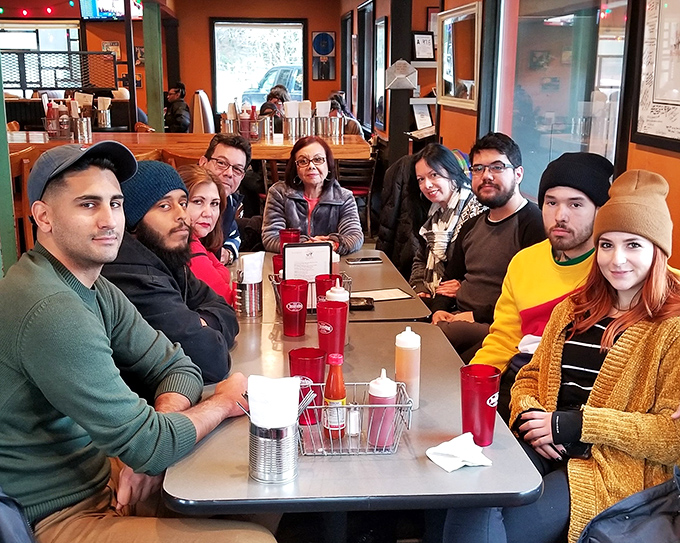 A gathering of happy diners proves that great barbecue, like music, brings people of all backgrounds together in harmony.