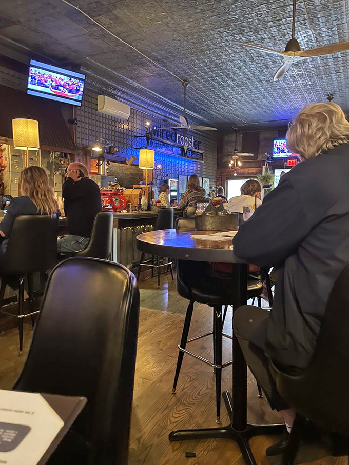 The dining room hums with the universal language of good food and conversation, under the watchful glow of those magnificent tin ceiling tiles.
