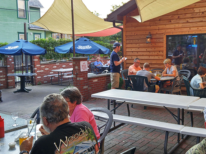 The outdoor dining area where locals gather under blue umbrellas. Some conversations just taste better with a side of fresh air.