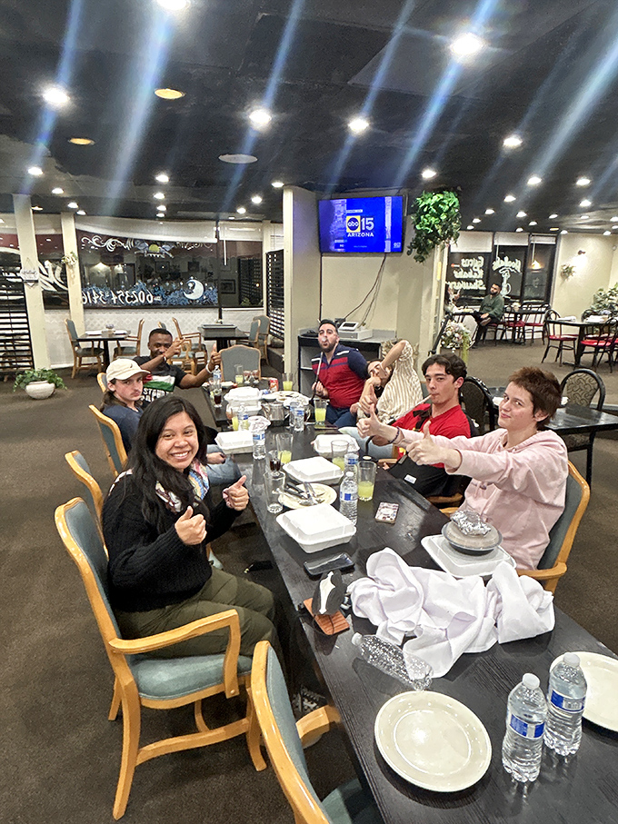 Happy diners giving the universal sign of culinary approval – the enthusiastic thumbs-up that transcends all language barriers.