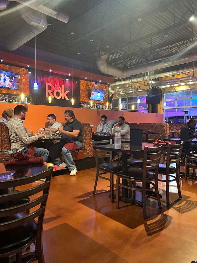 Diners engaged in the ancient art of stone cooking, with expressions ranging from "master chef" to "what have I gotten myself into?"