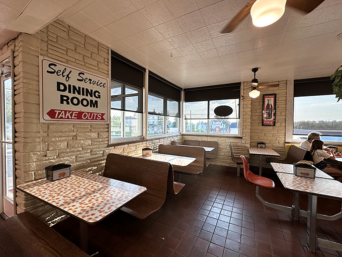 Booth seating that tells stories of decades of satisfied diners, with those signature orange starburst tablecloths that somehow make everything taste better. 