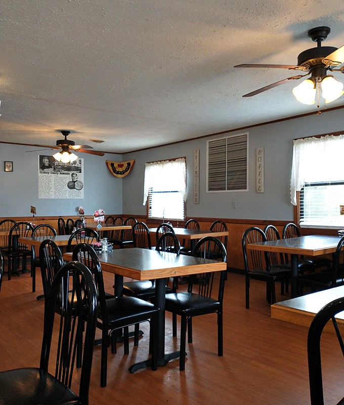 The dining room's wood paneling, ceiling fans, and simple decor create an atmosphere where you instantly feel like a regular, even on your first visit.