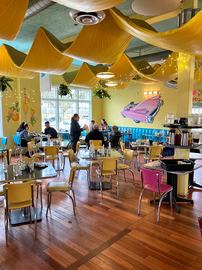 The dining room buzzes with conversation under golden fabric waves, proving breakfast is the most social meal of the day.