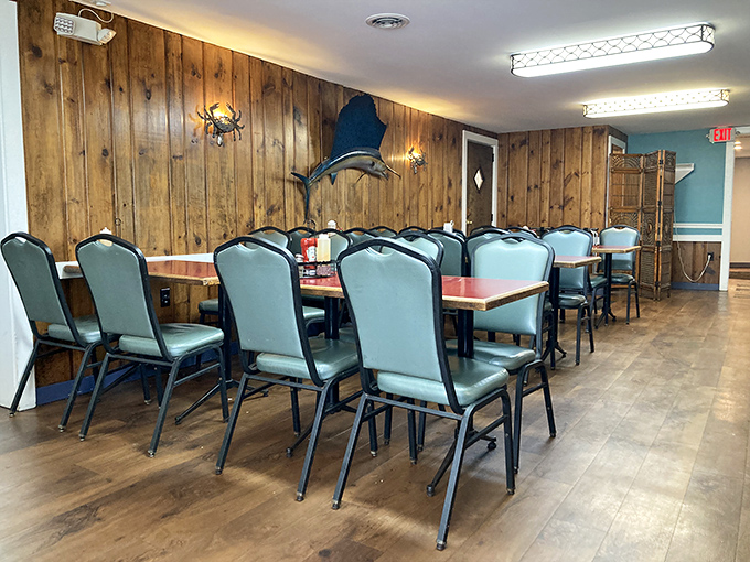 Wood-paneled walls adorned with maritime treasures create the perfect backdrop for seafood feasts and family gatherings.