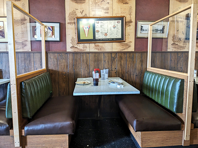 These cozy wooden booths with dividers offer the perfect balance of privacy and people-watching for your cheese coney consumption.