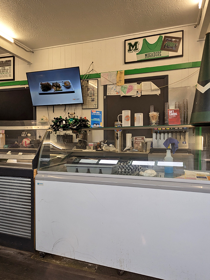 Behind the counter, where breakfast magic happens. That display case promises sweet endings to your savory beginnings.