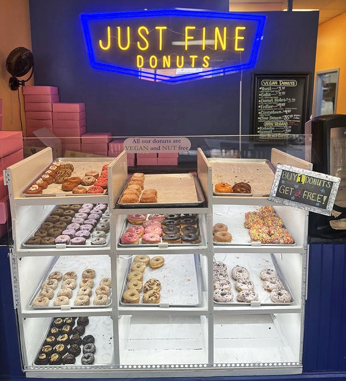 The "Just Fine Donuts" sign modestly undersells what are clearly extraordinary circles of joy. Buy four, get two free—math never tasted better!